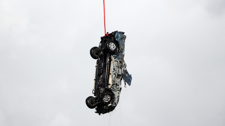 Helicopter used to recover cars swept out to sea by floods along Great ...